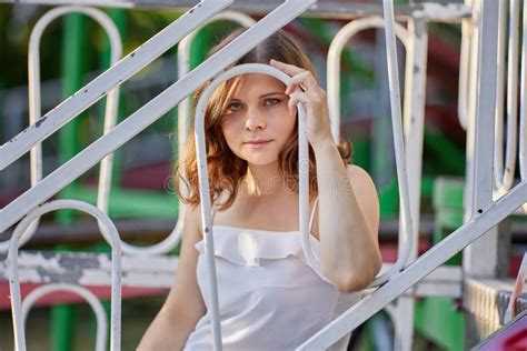Attractive Serious Woman Sits Behind Fence Outdoors Stock Image Image Of Graceful European