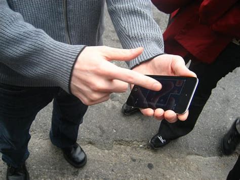 Man Holding Phone Kompulsa