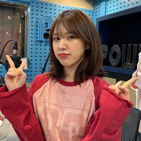 A Woman Holding Up Two Fingers In Front Of Her Face