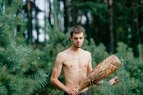 Premium Photo Odd Primitive Naked Man With Huge Wooden Stick Hunting