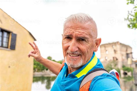 Handsome Middle Aged Man With White Goatee Taking A Selfie In The