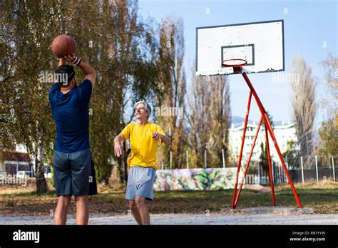 Senior Father And Son Playing Basketball In The Park Stock Photo Alamy