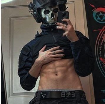 A Man Wearing A Helmet And Holding A Cell Phone In Front Of His Face