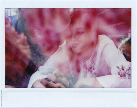 Polaroid Of A Man Kissing Woman In Cheek By Stocksy Contributor