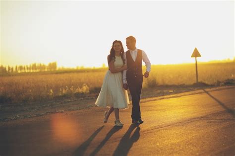 Premium Photo Wedding The Bride And Groom Hold Hands And Walk Along