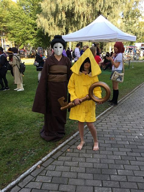 Two People Dressed Up As Characters In Costumes