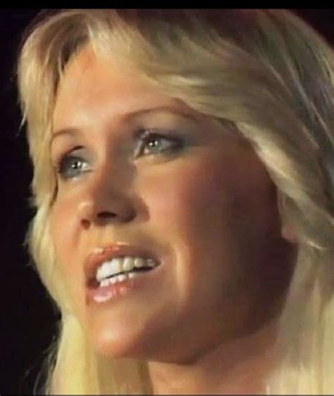 A Woman With Blonde Hair And Blue Eyes