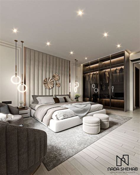A Large Bed Sitting In The Middle Of A Bedroom Next To A Couch And Ottoman