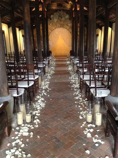 White Petals And Pillar Candles In Glass Lining Aisle Whim Florals