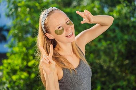 Premium Photo Smiling Woman Applying Hydrogel Eye Care Patches