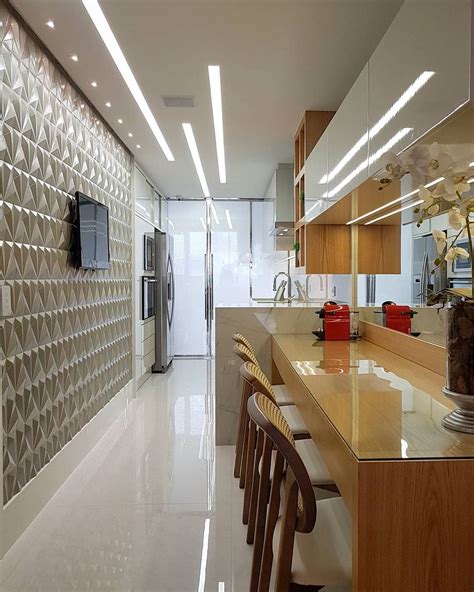 Cozinha Estreita Em Porcelanato Branca E Amadeirada Ilha E Parede