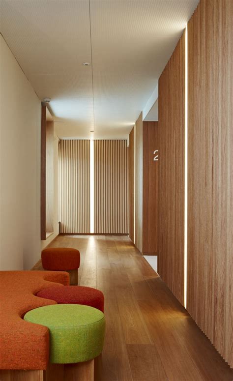 An Orange And Green Couch Sitting On Top Of A Wooden Floor Next To A
