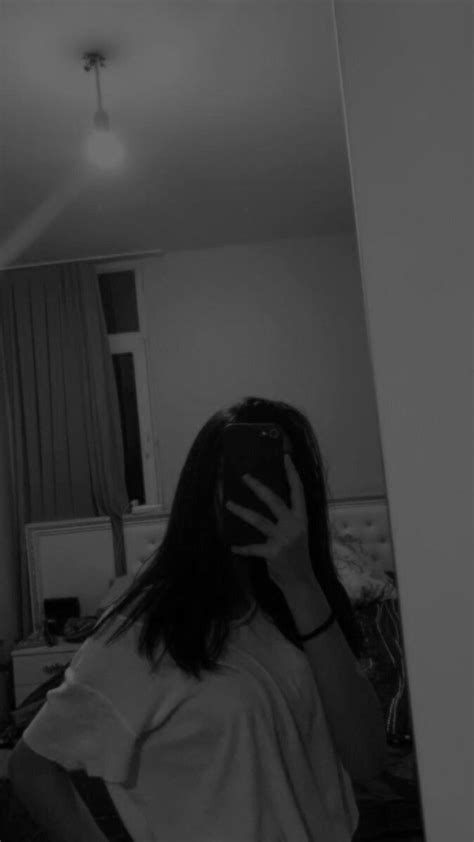A Woman Is Taking A Selfie In The Mirror