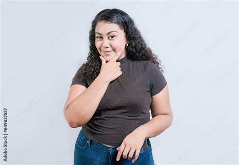 Beautiful Latin Girl Thinking With Hand On Chin Young Woman Rubbing Chin With A Doubtful