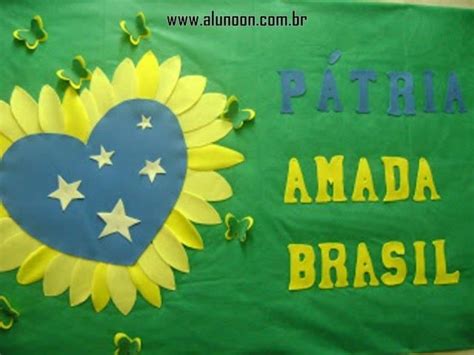 A Green Banner With Yellow And Blue Flowers In The Shape Of A Heart On It