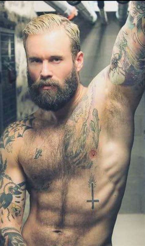A Man With Tattoos On His Arms And Chest