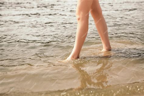 Premium Photo Close Up Naked Slim Woman Legs Walking Barefoot Along The River Female Feet On