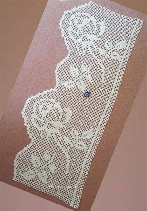 A Piece Of White Lace With A Button On It