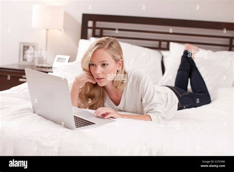 Women Laying On Bed Using Laptop Stock Photo Alamy