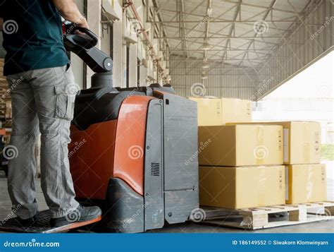 Warehouse Worker Driving Electric Forklift Pallet Jack Loading Shipment