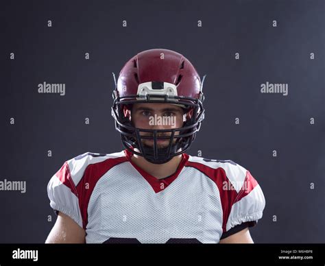Portrait Of A Strong Muscular American Football Player Isolated On Gray