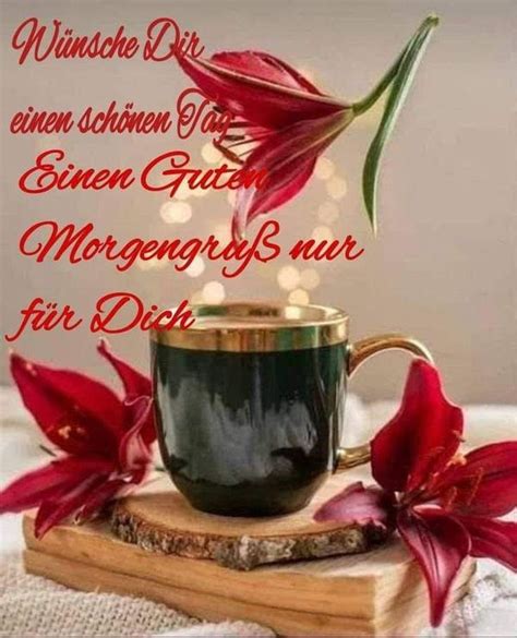 A Coffee Cup Sitting On Top Of A Wooden Table Next To Red Flowers And A