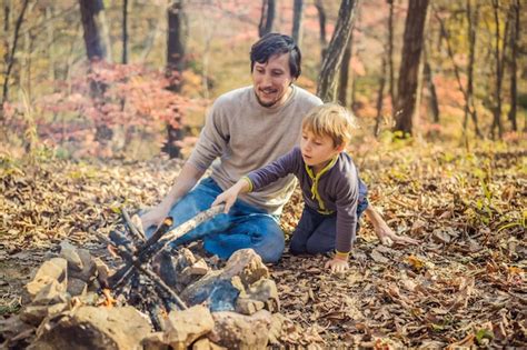 Premium Photo Father And Excited Son Sitting In Tent In Forest