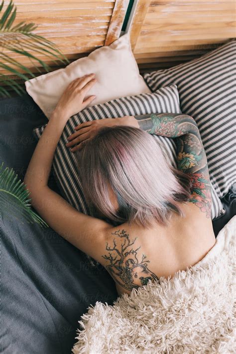 Tattooed Naked Woman On The Bed Del Colaborador De Stocksy Alexey