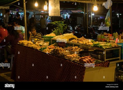 An Asian Food Vendor Selling Street Food At The Phnom Penh Night