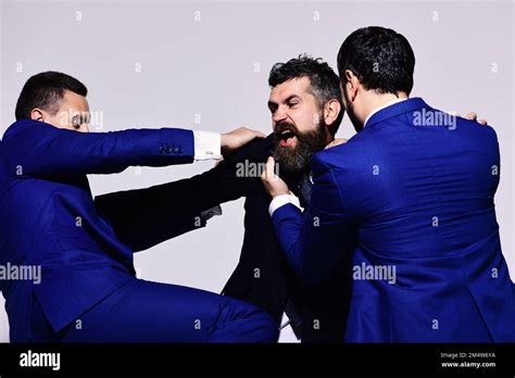 Businessmen With Mad Faces In Formal Suits On Grey Background Business