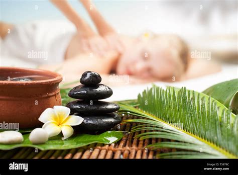 Spa Massage Under Tropical Palm Beautiful Young Woman Getting Spa Massage Focus On Spa Objects