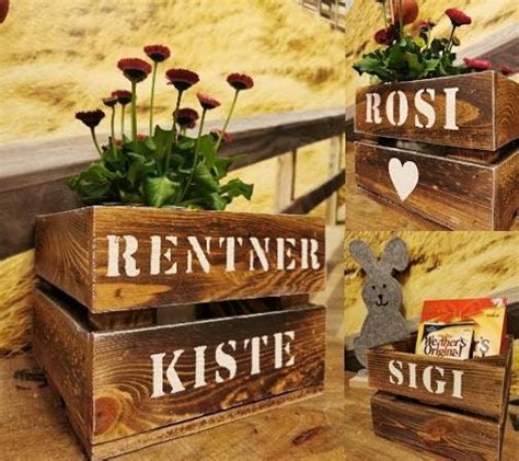 Two Wooden Boxes With Flowers In Them Sitting On A Table Next To A Sign