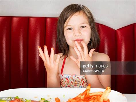 Girl Licking Fingers Stock Fotos Und Bilder Getty Images