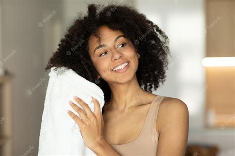 Premium Photo Smiling African American Woman Drying Wet Hair With Towel After Shower