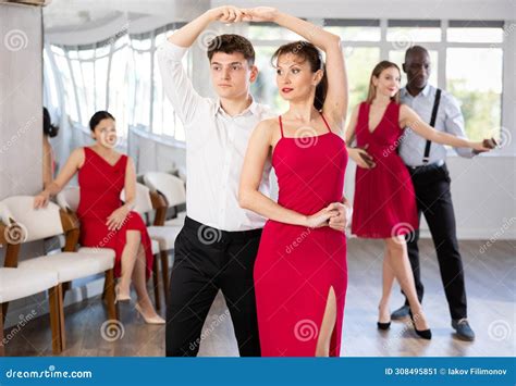 Hispanic Guy Practicing Samba With Woman In Red In Dance Class Stock Image Image Of Together