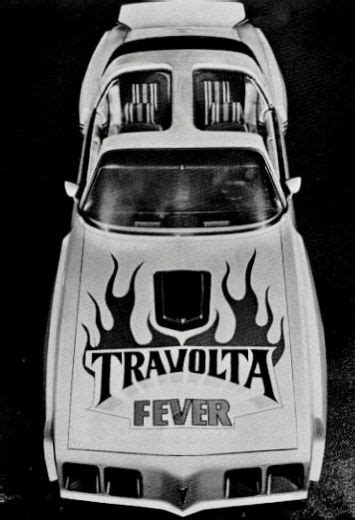 An Old Photo Of A Car With Flames On The Front And Back End In Black