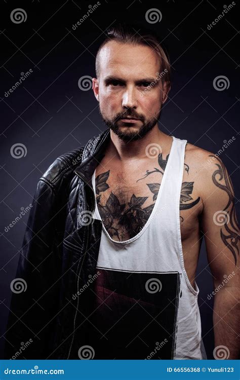 A Man With Tattooes On His Arms Silhouette Of Muscular Body Stock