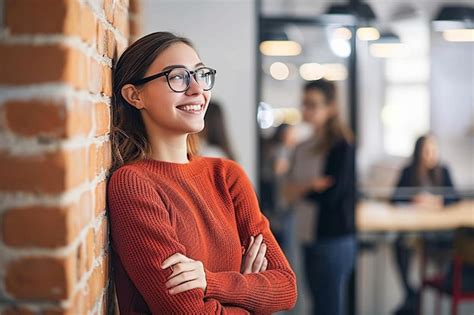 Premium Photo A Woman Leaning Against A Brick Wall With Her Arms Crossed