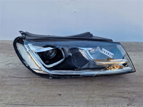VW TOUAREG 7P LIFT PRAWA LAMPA PRZÓD BI XENON SKR 12717049608