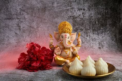 Idol Of Lord Ganesha With Modak Sweet Dish And Flower Ganesh Chaturthi