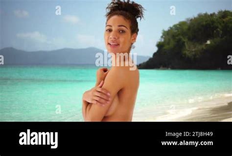Lovely African Woman Standing Topless On Caribbean Beach Of Bahamas