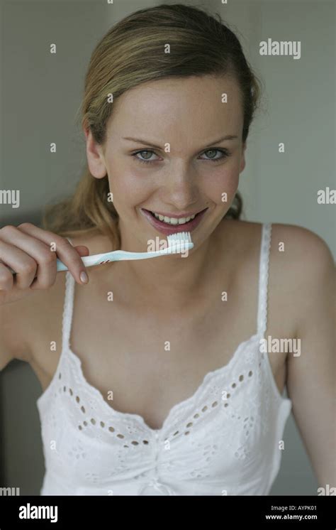 A Blonde Woman Brushing Her Teeth Stock Photo Alamy