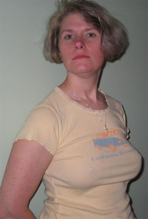 A Woman Is Posing For The Camera With Her Hands On Her Hips And Wearing A Yellow Shirt
