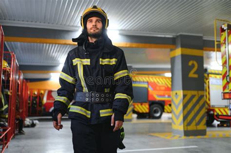 Fireman Wearing Protective Uniform Standing In Fire Department At Fire