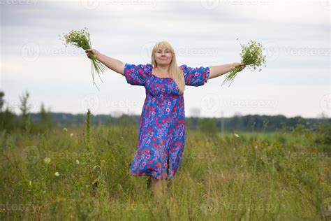 Beautiful Plus Size Woman With White Hair In A Summer Dress Posing Outdoors With Daisies Chubby