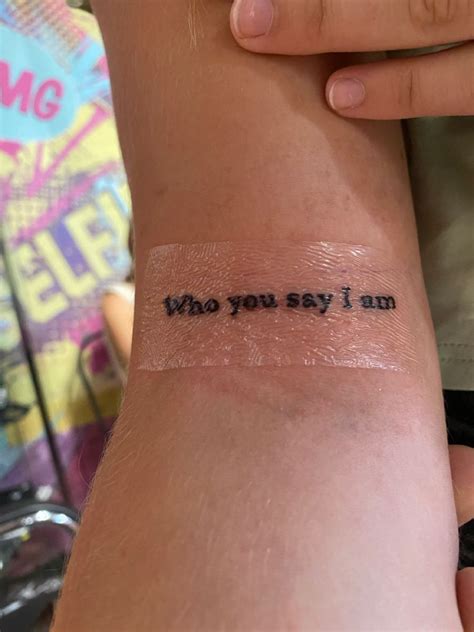 A Person With A Tattoo On Their Arm That Says Who You Say I Am