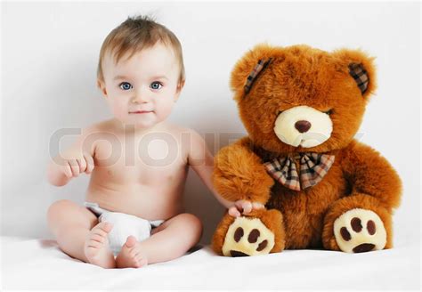 Lille Dreng Sidder Ved Siden Af En Bamse Stock Foto Colourbox