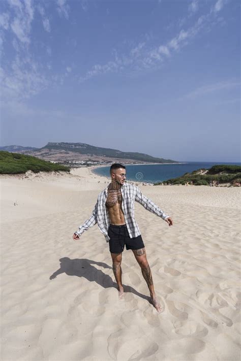 Handsome Half Naked Caucasian Man Walking On The Sand Enjoying His