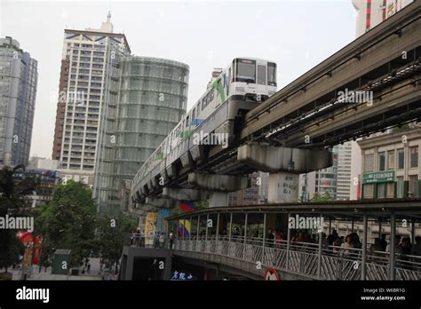 A Monorail Train Of Chongqing Light Rail Line Passes Through A Glass
