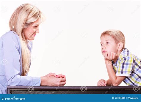 Mother And Son Talk And Argue Sit At Table Stock Image Image Of